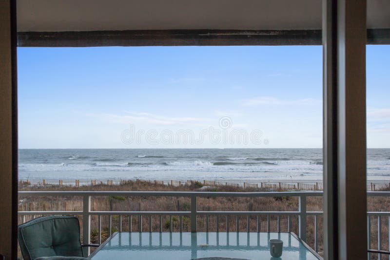View of Beach from Apartment Balcony Empty with Table and Armchairs ...