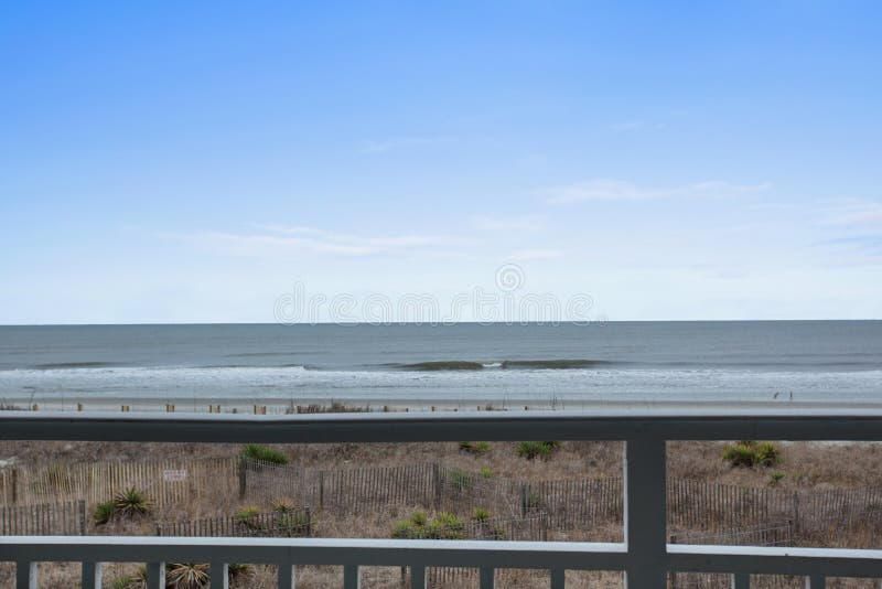 View of Beach from Apartment Balcony Empty with Table and Armchairs ...