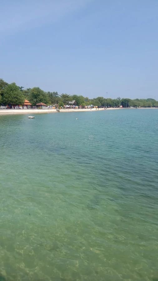 View of the Beach with Its Blue-green Water with White Sand and Shady ...