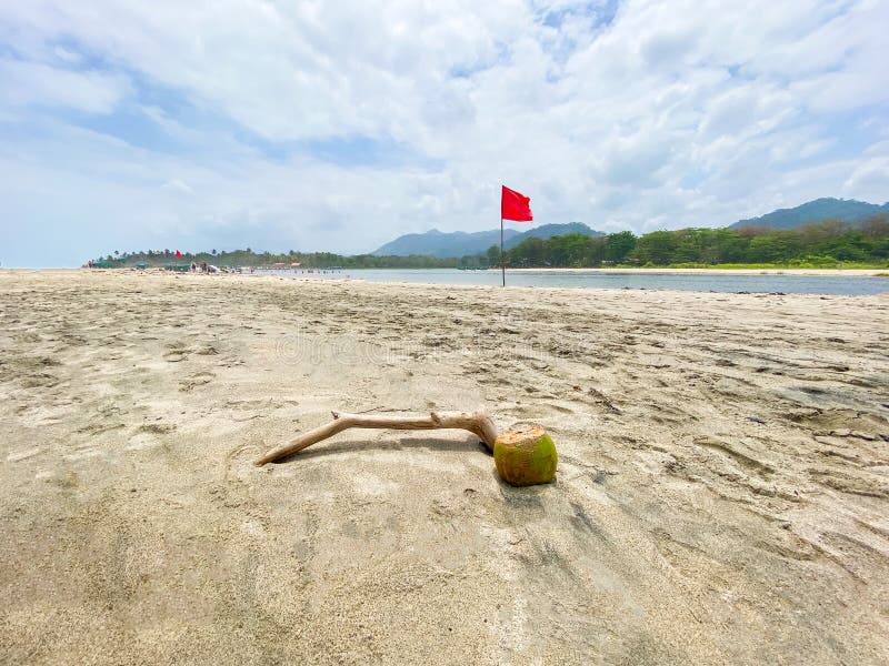 View of a Beach with a Red Danger Flag Stock Photo - Image of water ...