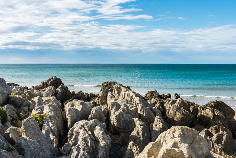 View of the Beach with Rocks and Sand between Cliffs Stock Image ...
