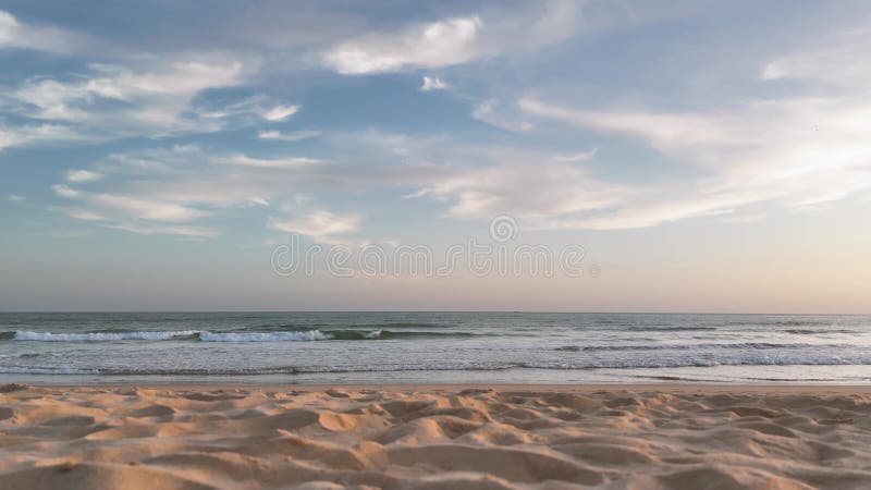 View of the Beach with Sand in Foreground and Feathery Clouds in ...