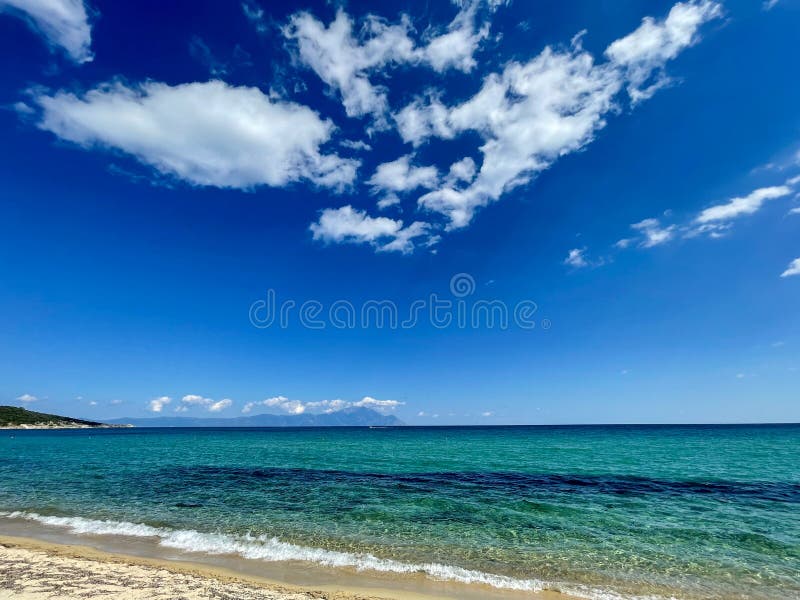 View from the Beach in Sarti, with Crystal Clear, Blue Water and Clouds ...