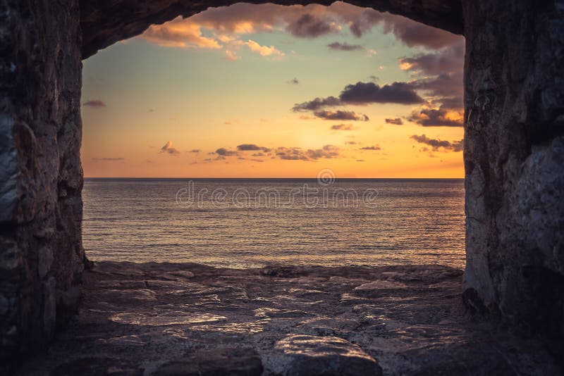 View of Beautiful Sunset Over Sea through Window of Old Building with ...