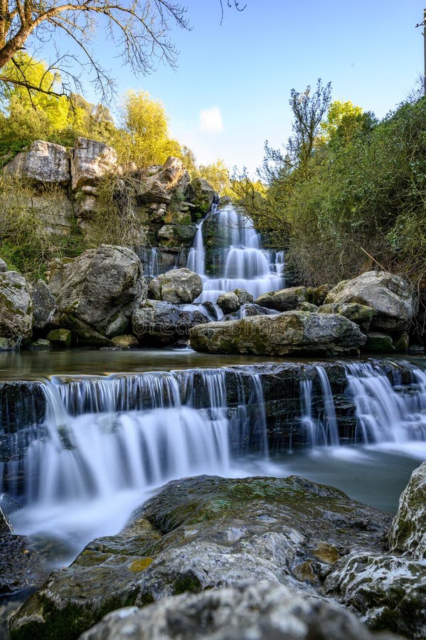 View of a Beautiful Waterfall with Trees Alongside Stock Photo - Image ...