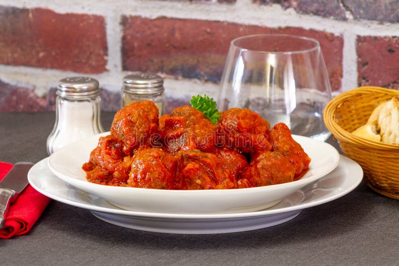 Beef Dumpling in Tomato Sauce in a Plate on a Table Stock Image - Image ...