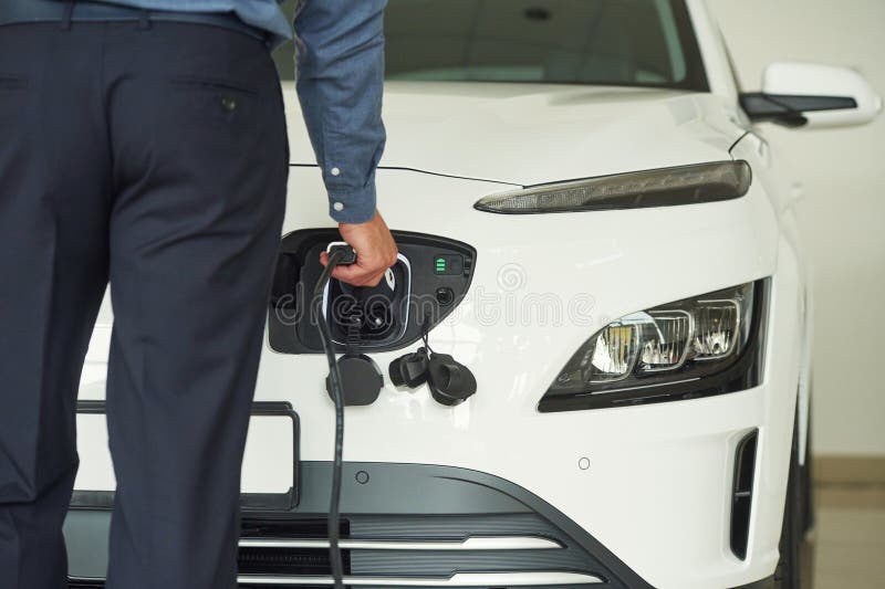 Putting Charger into Electrical Car Socket. Close Up View of Man Stock ...