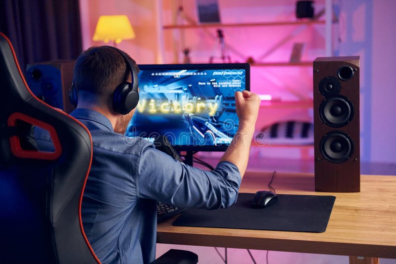 View from Behind. Online Streamer Playing FPS Shooter Game at Home ...