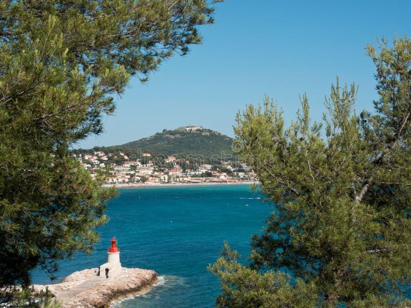 View from Behind Trees of a Lighthouse on the Mediterranean and ...