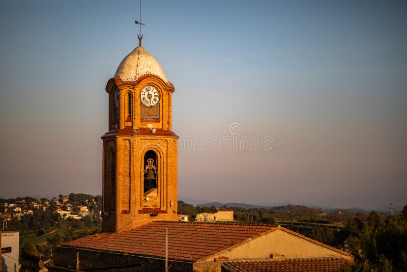 Bell Tower Illuminated by the Sunset Orange Light and Blue Sky Stock ...
