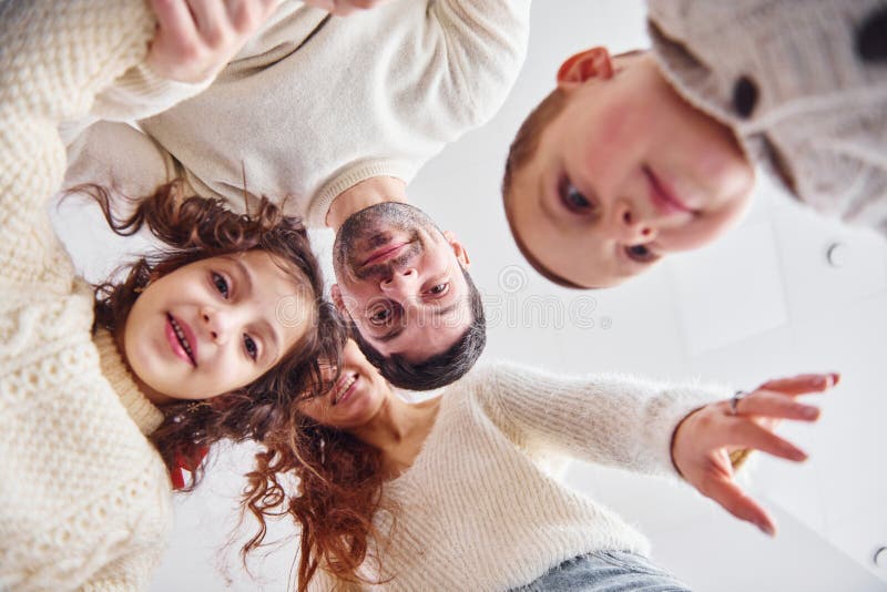 View from Below. Happy Family Looking Down and Having Fun Stock Photo ...
