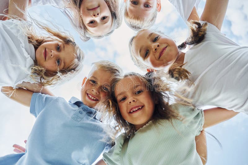 View from Below of Happy Kids that are Standing Together and Looking ...
