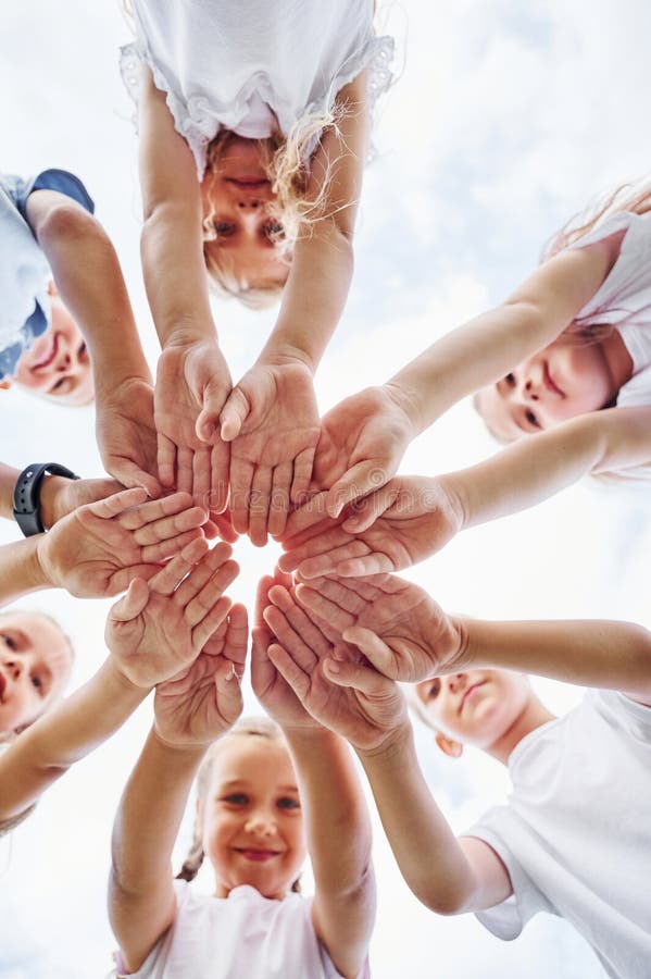 View from Below of Kids that are Holding Hands Together. Against White ...