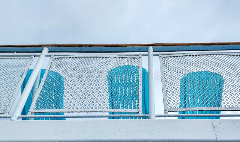 A View from Below of the Railing and the Backs of the Deck Chairs on ...