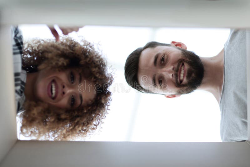 View from Below a Young Couple Looking Inside the Box. Stock Photo ...