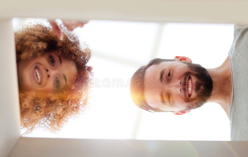View from Below a Young Couple Looking Inside the Box. Stock Photo ...