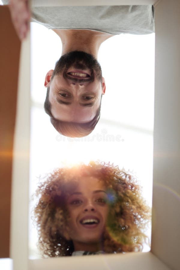 View from Below a Young Couple Looking Inside the Box. Stock Image ...