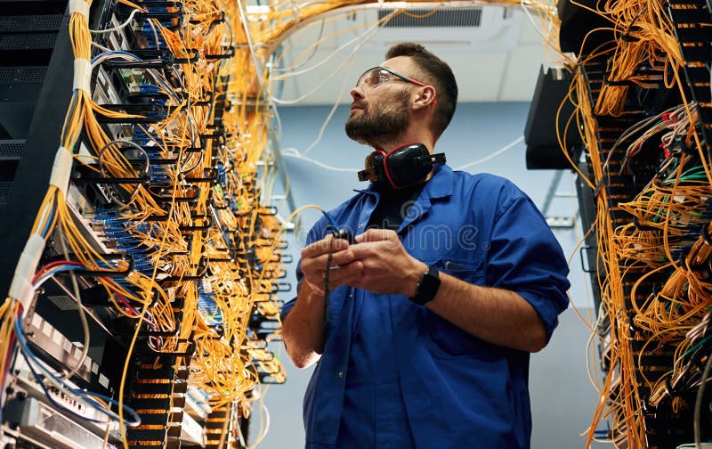 View from Below. Young Man is Working with Internet Equipment and Wires ...