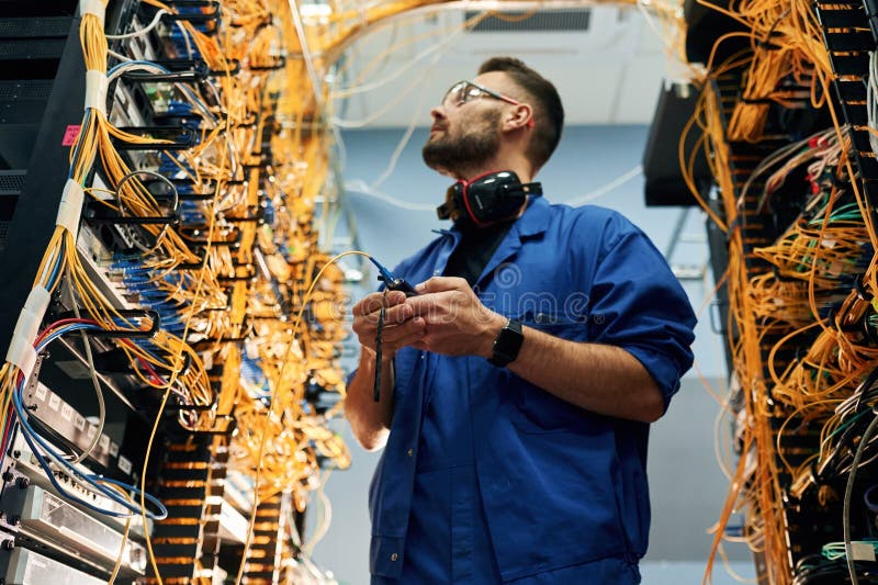 View from Below. Young Man is Working with Internet Equipment and Wires ...