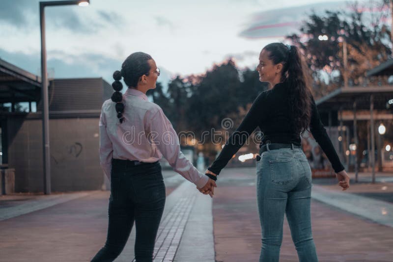 View of Best Friends Walking on the Street while Holding Hands Stock ...
