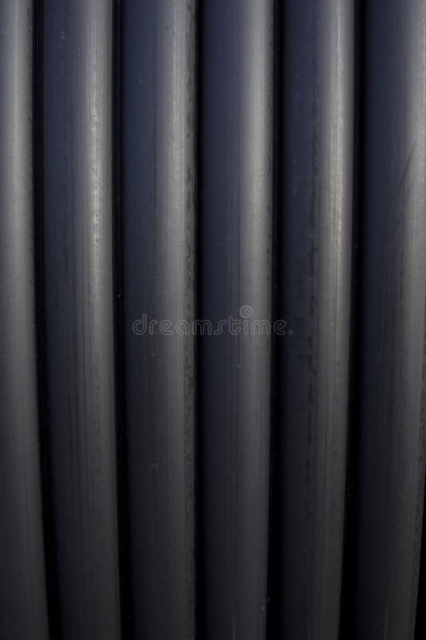 View of Black Plastic Tubes Vertically for Abstract Uneven Background ...