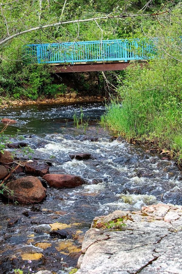 View of a Blue Bridge Walkway Over a Small River Stock Image - Image of ...