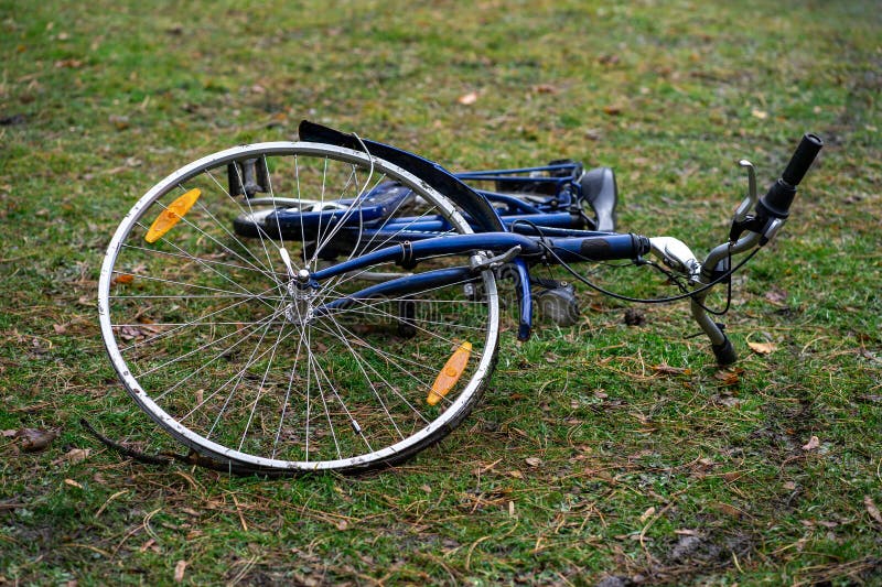 View of a Blue Broken Bicycle Lying on Green Grass. Stock Photo - Image ...