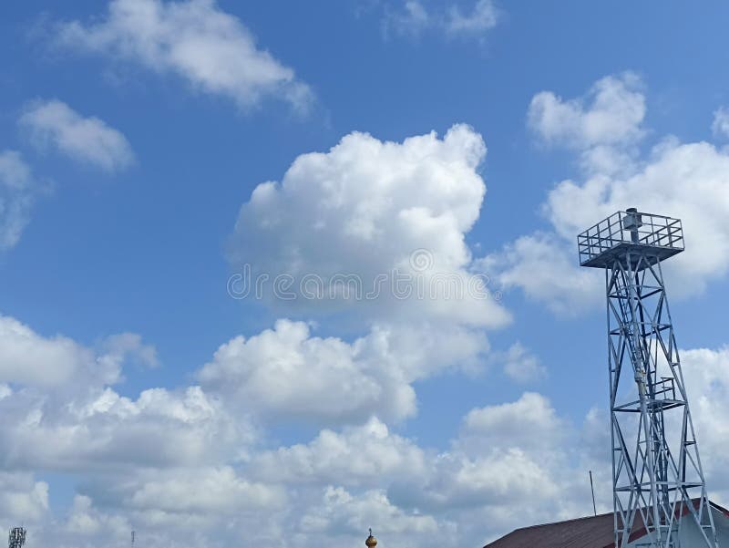 View of Blue Clouds and Watchtower Stock Photo - Image of clouds, pant ...