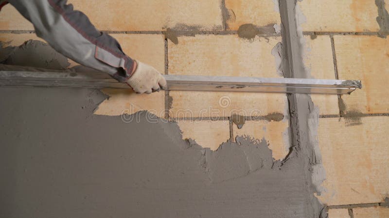 View of Builder Hands Plastering on Block Wall. Worker Leveling the ...