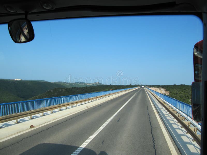 View from the Bus Window on an Empty Road and Mountains Covered with ...