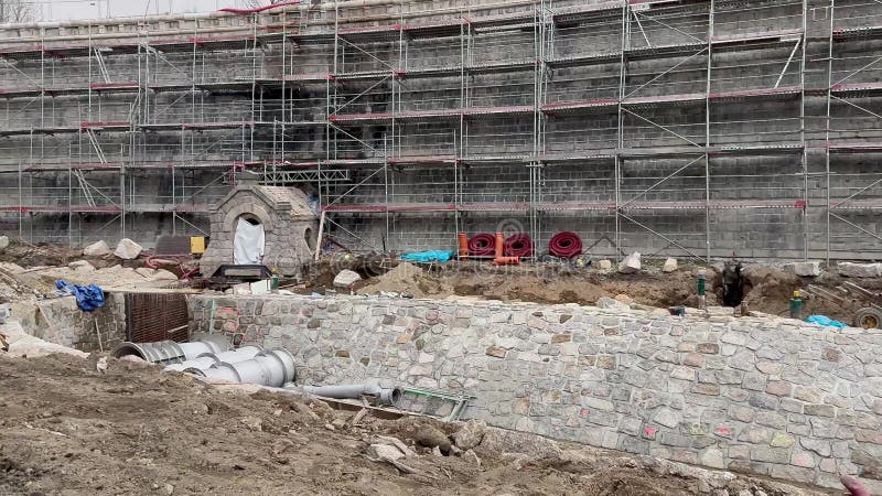 A Construction Site Featuring Scaffolding, Materials, and Various ...