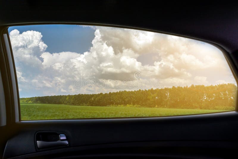 View from the Inside of the Car Window on a Field Under a Blue Sky with ...