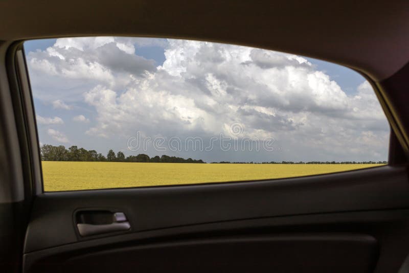 View from Car Window while Traveling on Fields and Sky with Clouds ...