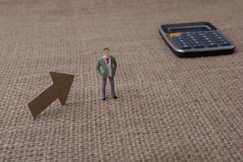 View of a Cardboard Pointer, a Suited Male Toy, with a Calculator on a ...