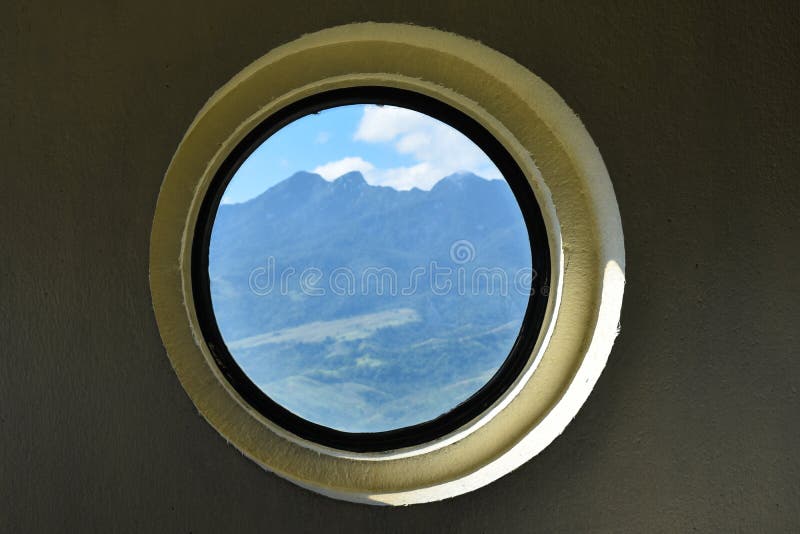 A View from a Circular Window of a Building Overlooking a Mountain ...