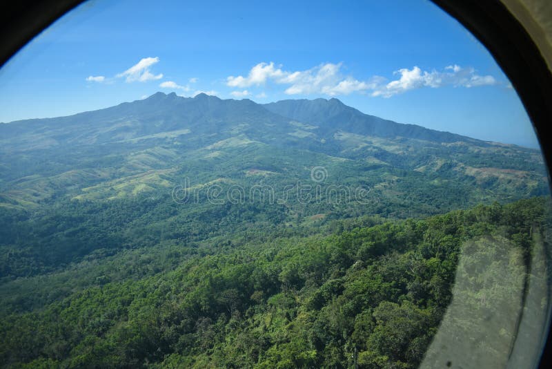 A View from a Circular Window of a Building Overlooking a Mountain ...