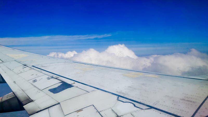 View of Clouds and Airplane Wings from Inside the Plane. the Sky is ...