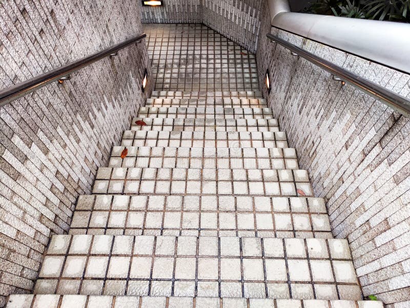 A View of a Concrete Staircase with Three Steps, Flanked by Brick Walls ...