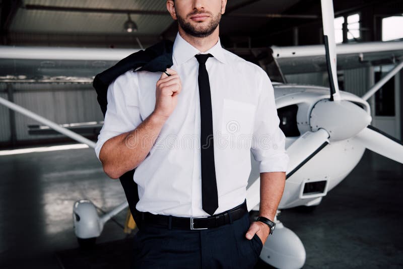 View of Confident Pilot Standing with Hand in Pocket Near Plane Stock ...