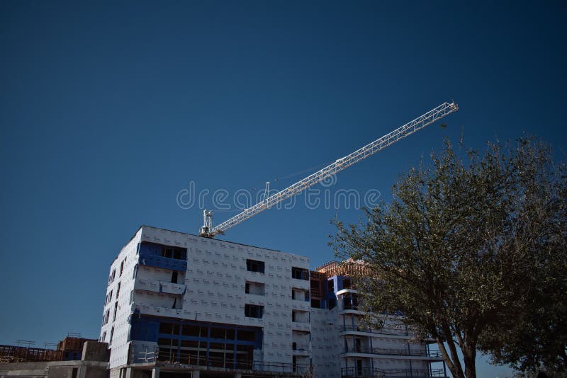 View of a Construction Crane Behind the Building Against the Background ...