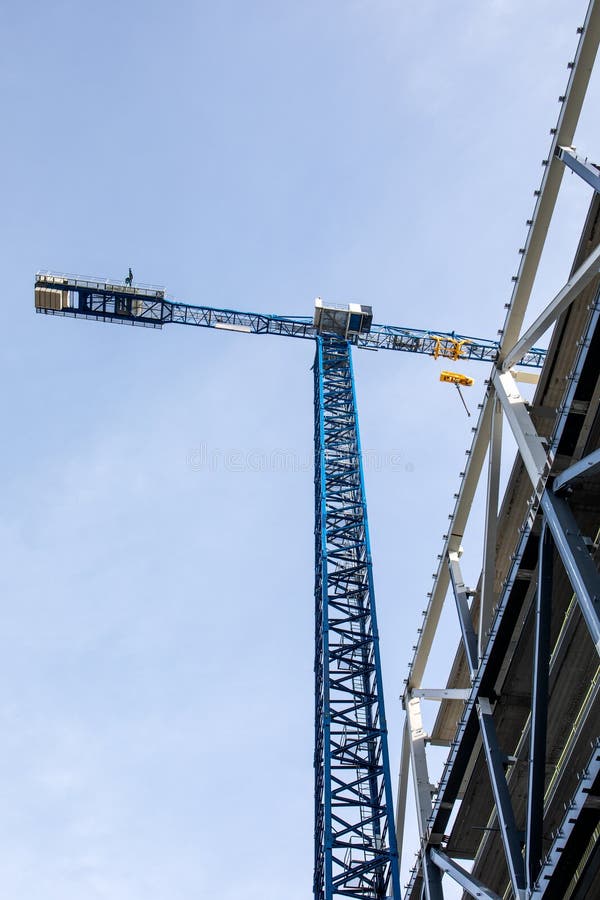 View of a Construction Crane with Steel Frame Building in the ...