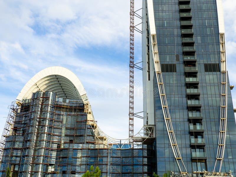 View of the Construction of a High-rise Building with a Crane. Modern ...