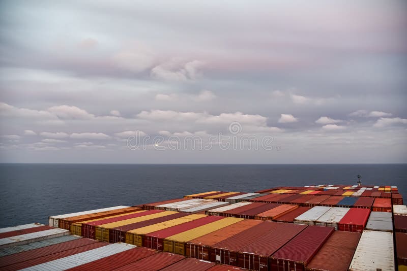Container Ship Sailing through Calm Sea on a Cloudy Day. Stock Photo ...
