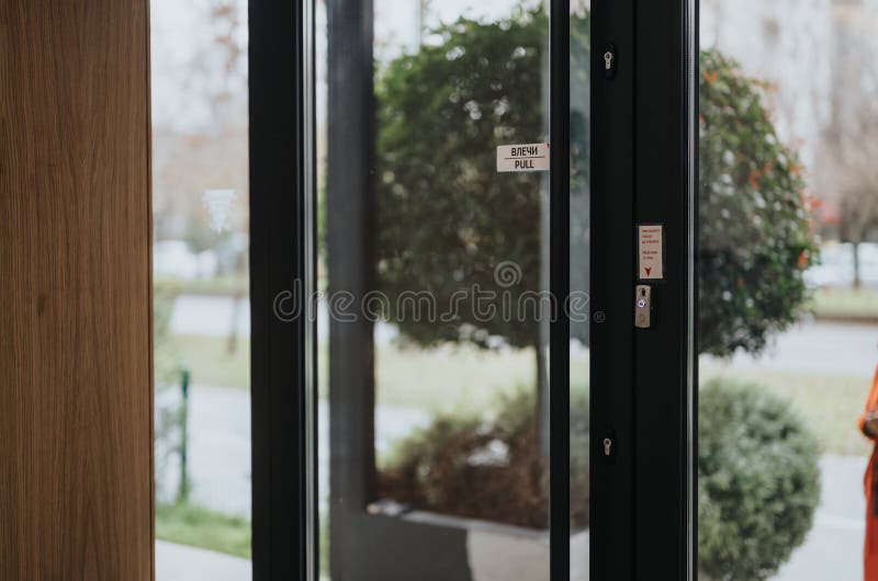 Modern Glass Door with Pull Sign and Electronic Access Control Panels ...