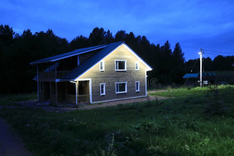View of cottage at night stock image. Image of dwelling - 233337073