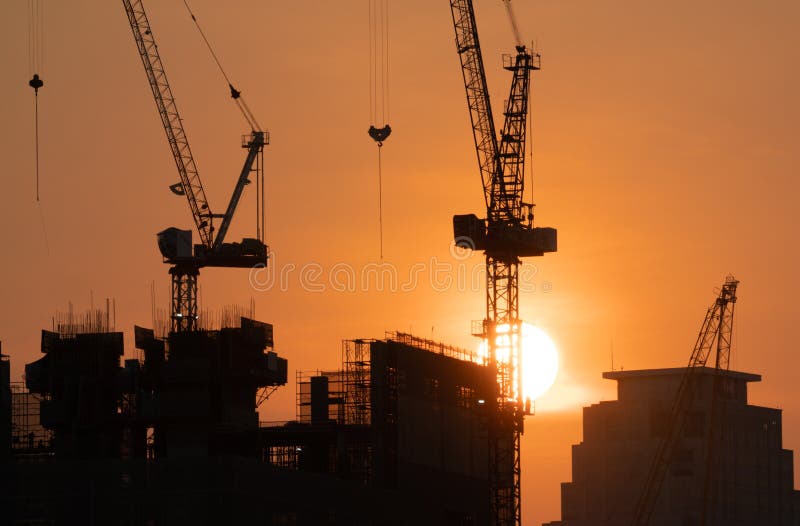 View of cranes at sunset stock photo. Image of construction - 242731218