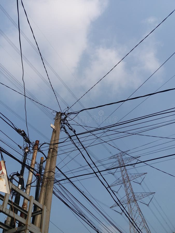 A View of Dangling Power Lines Against a Backdrop of High-voltage ...