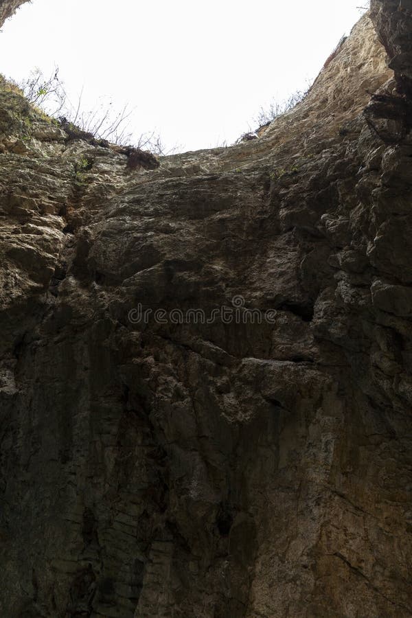 View from a Deep Cave To the Gloomy Sky. Close-up Stock Image - Image ...