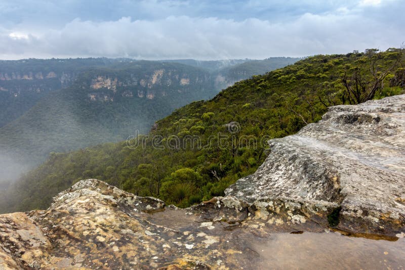 View of Deep Valley and Rolling Hills from a Rocky Cliff Edge Stock ...