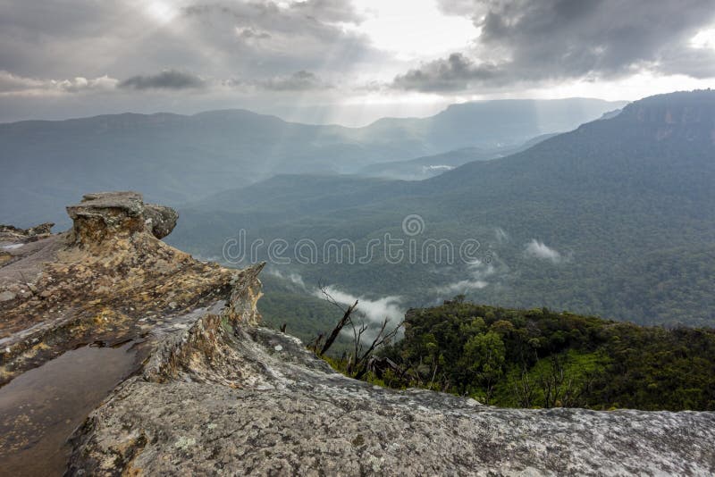 View of Deep Valley and Rolling Hills from a Rocky Cliff Edge Stock ...